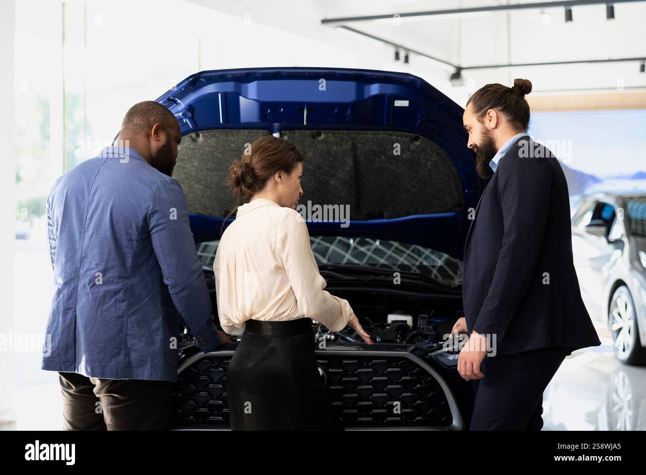 Dealership salesman providing in depth knowledge about vehicle features ...