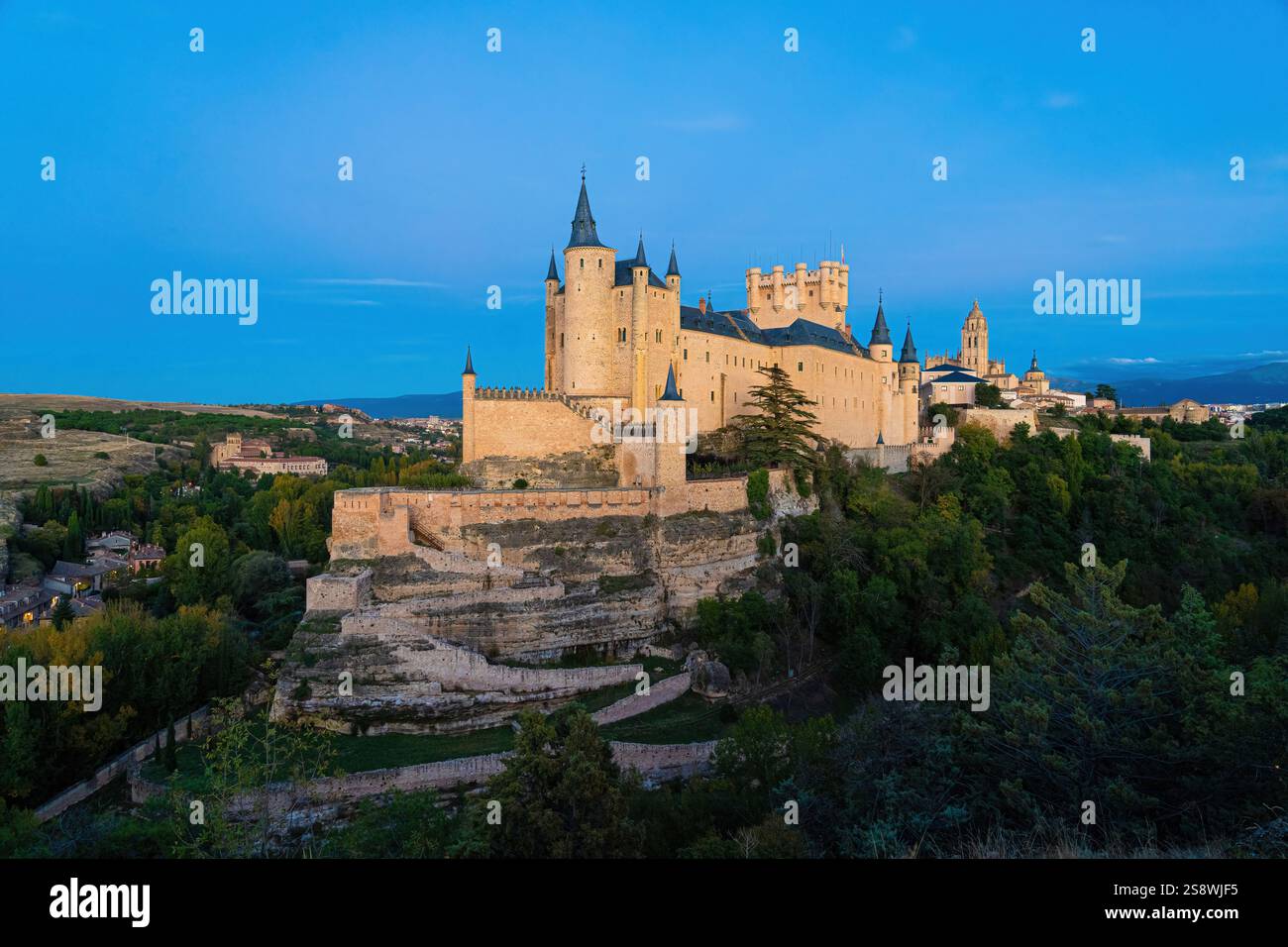 Alcázar of Segovia at night, a medieval castle built on a rocky crag in ...