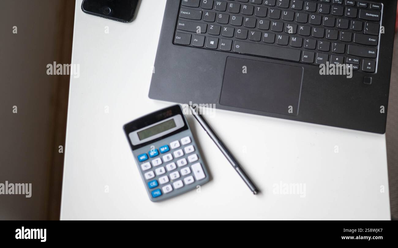 Laptop computer with calculator and smartphones Stock Photo - Alamy