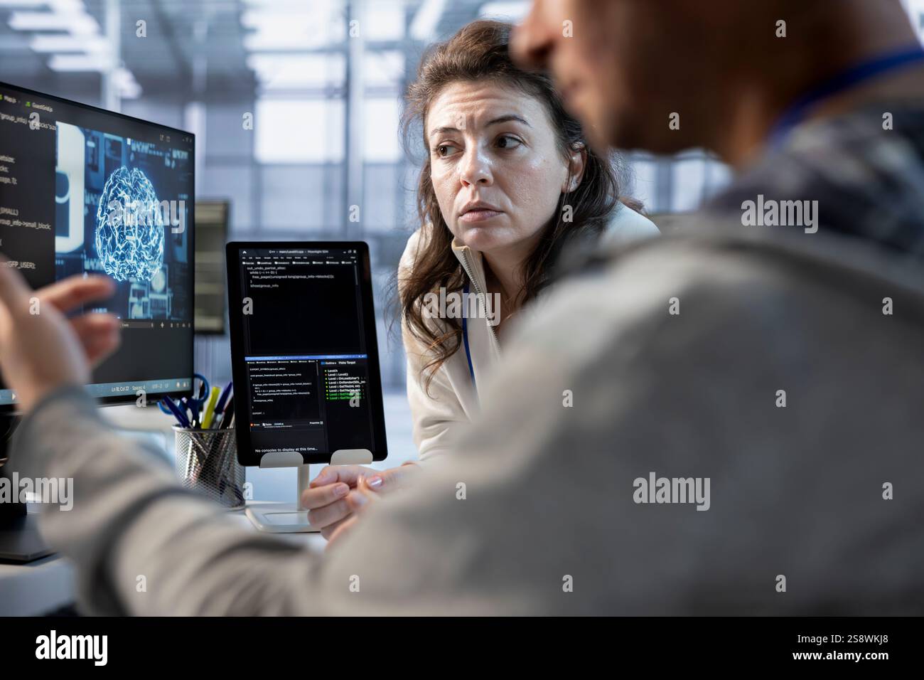 Engineer working with colleague on computer in artificial intelligence data center establishment ...