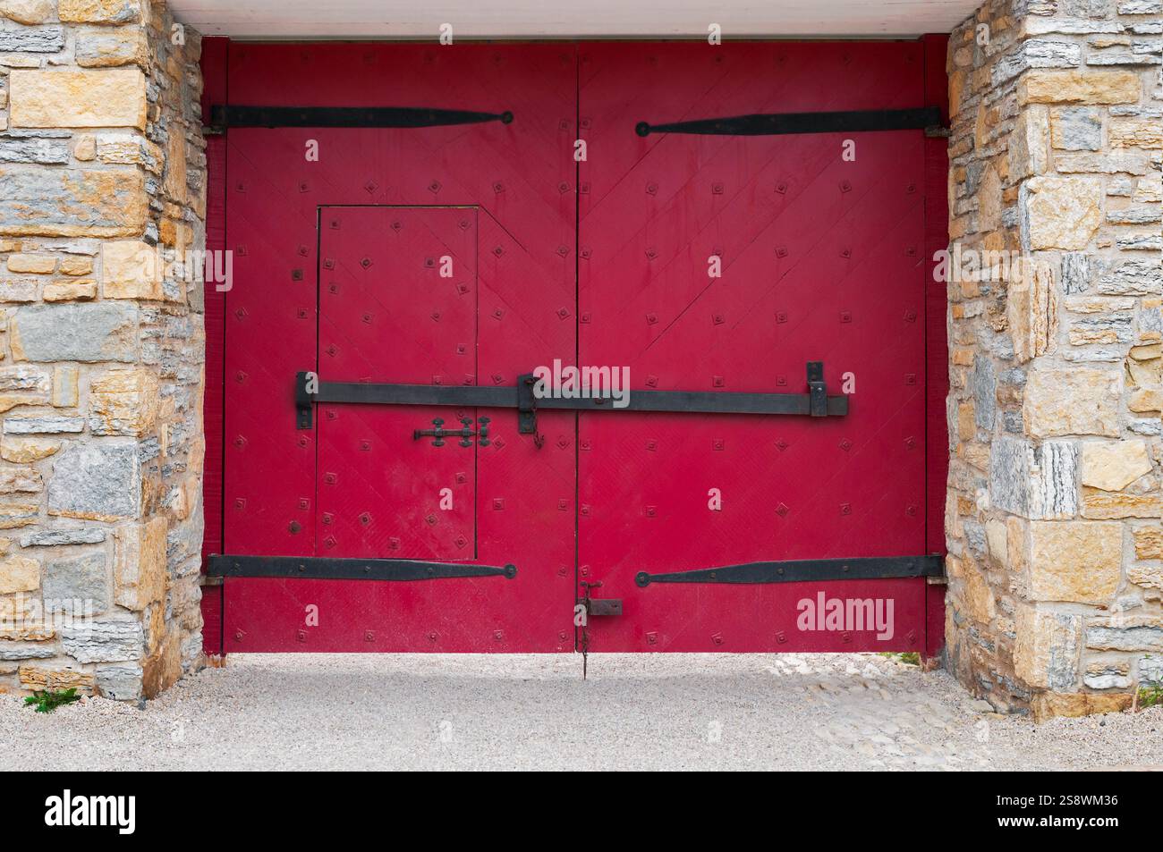 Red Doors Closed With Black Metal Bars in Stone Wall - old Stock Photo ...
