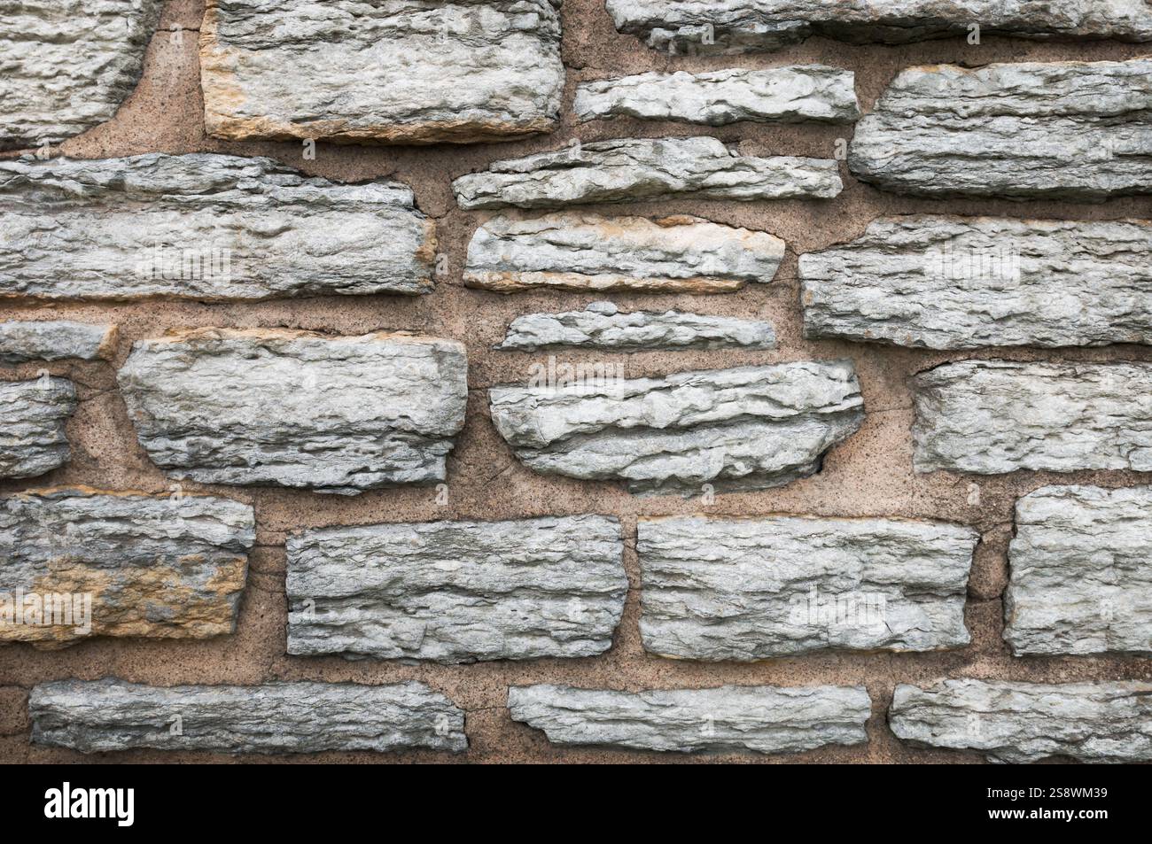 White Stone Mortared Into Red Wall - close up Stock Photo - Alamy