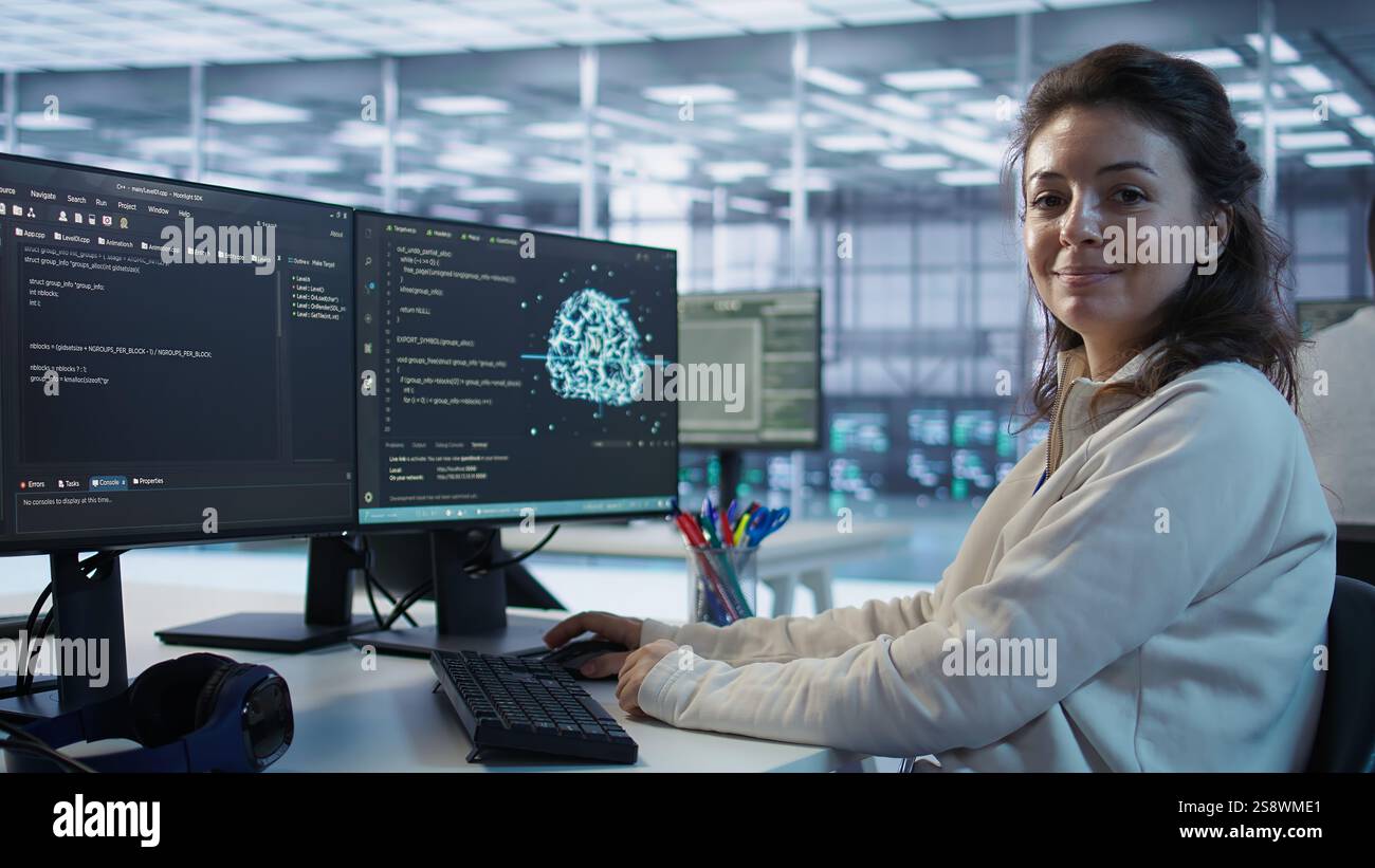 Portrait of smiling technician programming in AI data center used for machine learning training ...