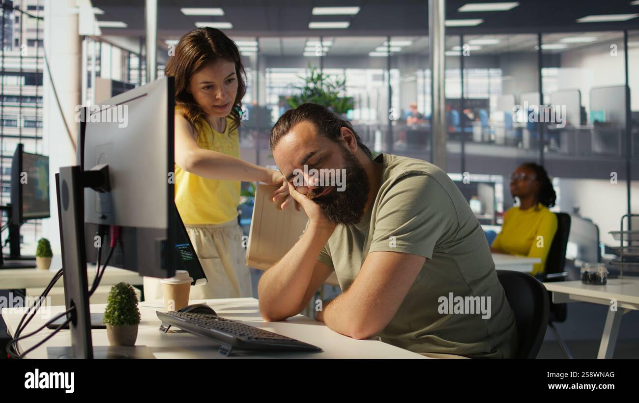 Tired company worker caught falling asleep at desk in office by ...