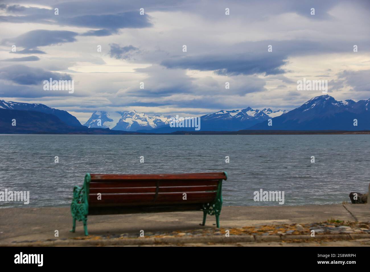 Bench facing the Admiral Montt Gulf on the waterfront of Puerto Natales ...
