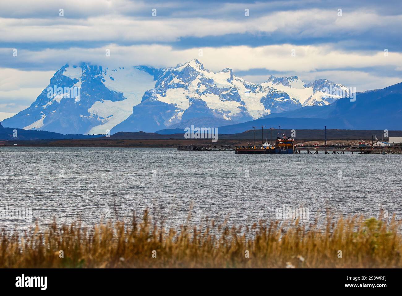 Snow capped mountains seen across the gulf from Puerto Natales ...