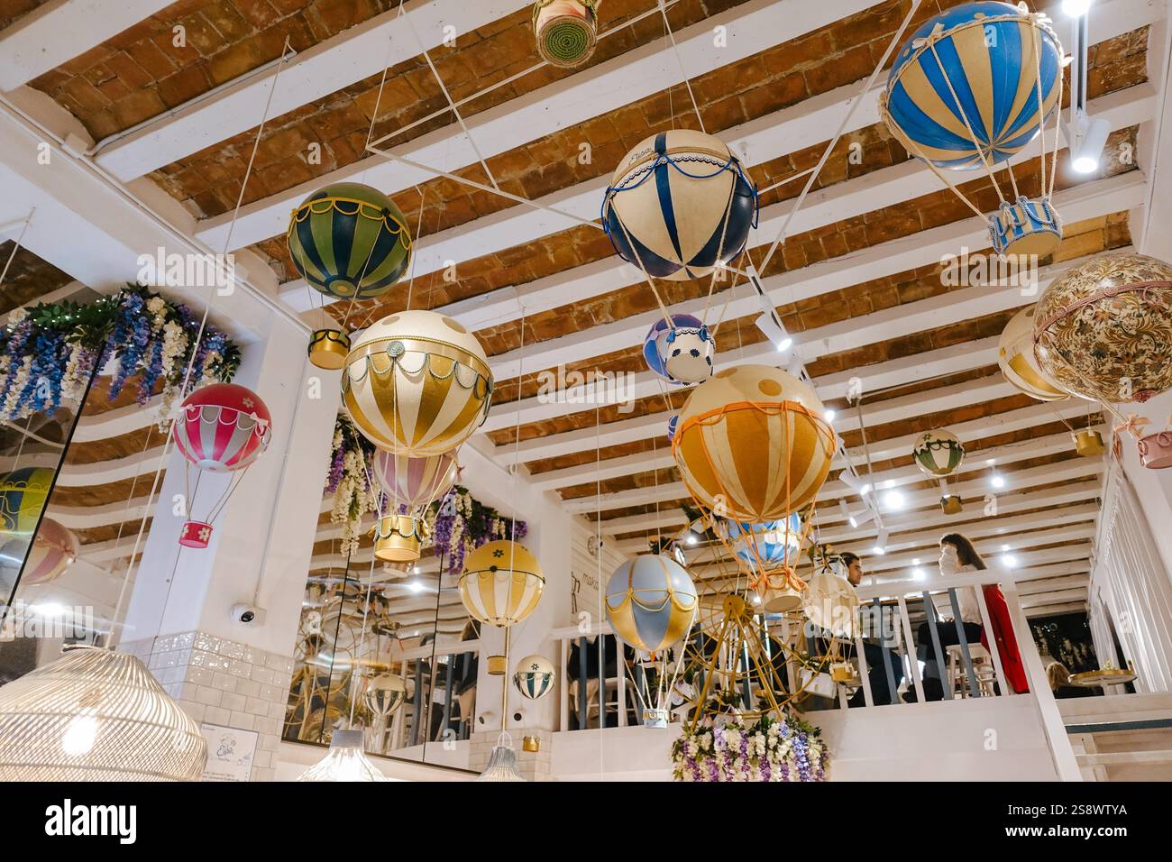 Inside a charming cafe in Barcelona, Spain, decorated with hot air ...