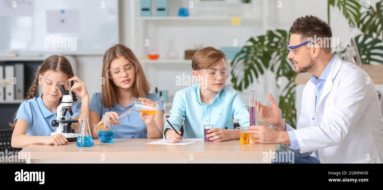 Teacher conducting chemistry lesson in classroom Stock Photo - Alamy