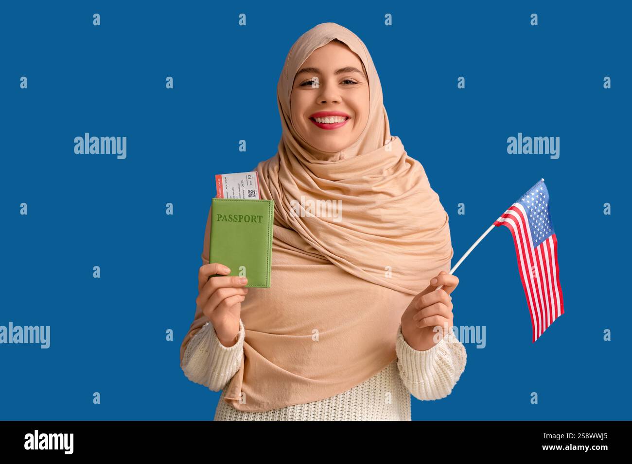 Beautiful young happy Muslim woman with USA flag, passport and ticket ...
