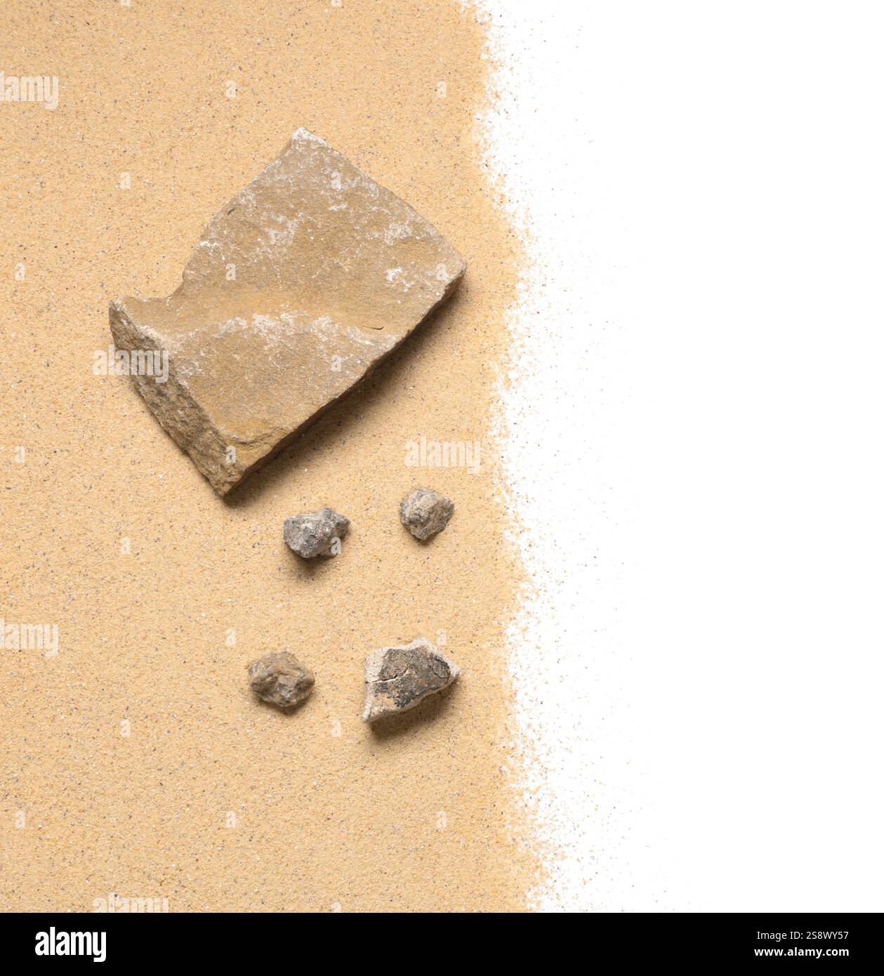 Light beach sand with stones on white background Stock Photo - Alamy