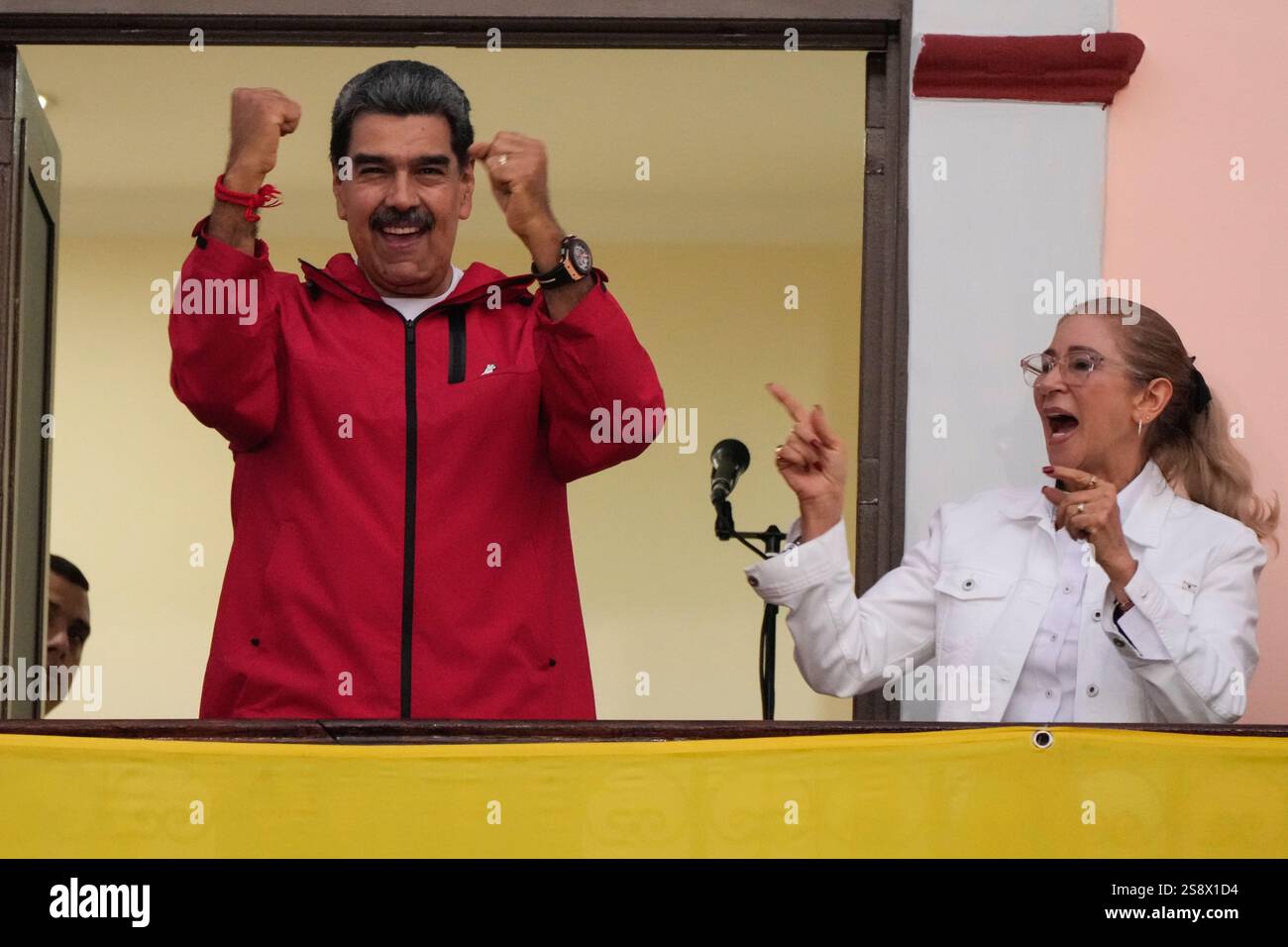 Venezuelan President Nicolas Maduro and first lady Cilia Flores gesture ...