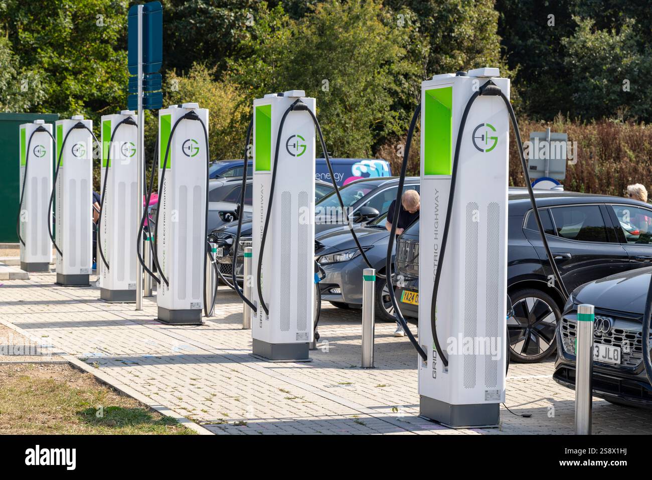 Gridserve electric vehicle chargers with electric vehicles plugged in ...