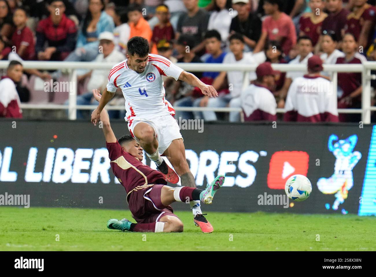 Venezuela's Sebastian Castillo tackles Chile's Yahir Salazar during a South American U-20 ...