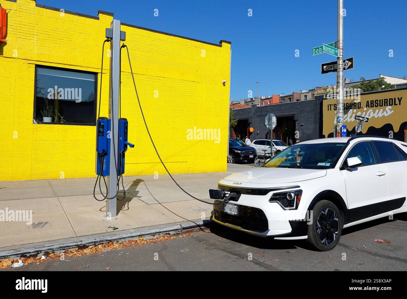 An electric vehicle plugged into a FLO EV charger at a PlugNYC curbside ...