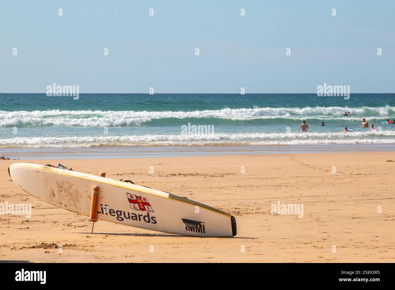 An RNLI Surf Rescue surfboard on Fistral Beach, Newquay, Cornwall, UK ...