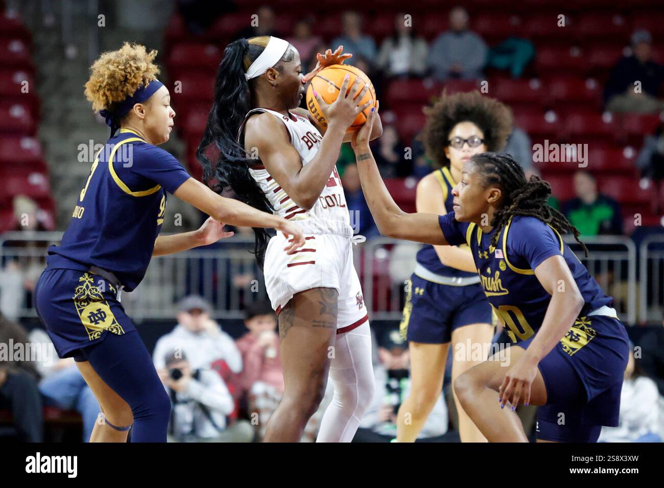 Boston College guard Dontavia Waggoner, center, looks to pass under pressure from Notre Dame ...
