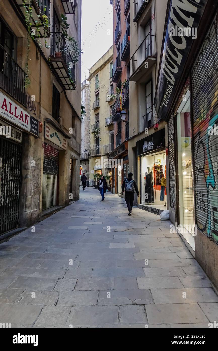 Narrow and dark street or alley with ancient stone buildings on both ...