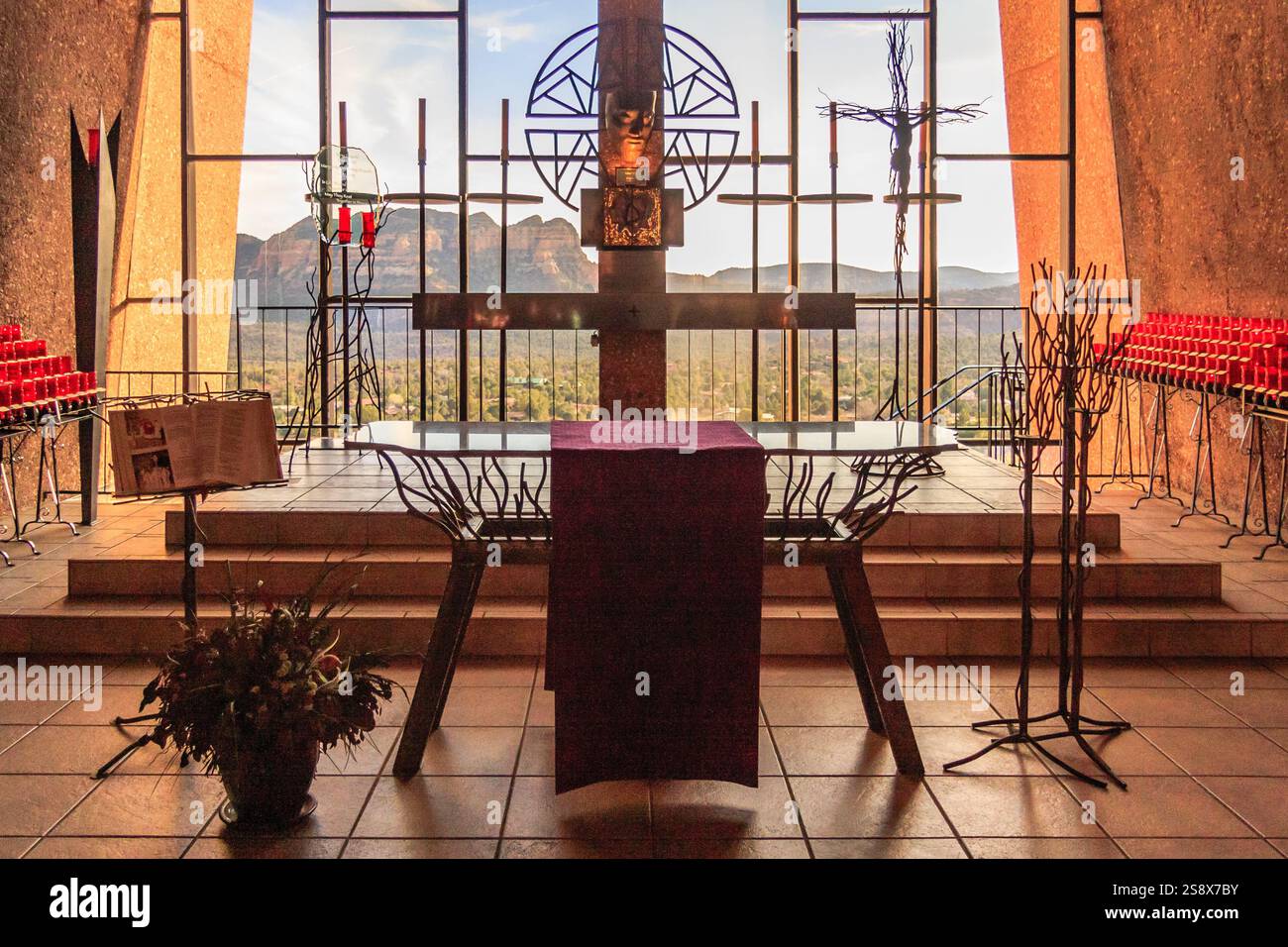 A church with a cross on the altar and a view of mountains. The altar ...