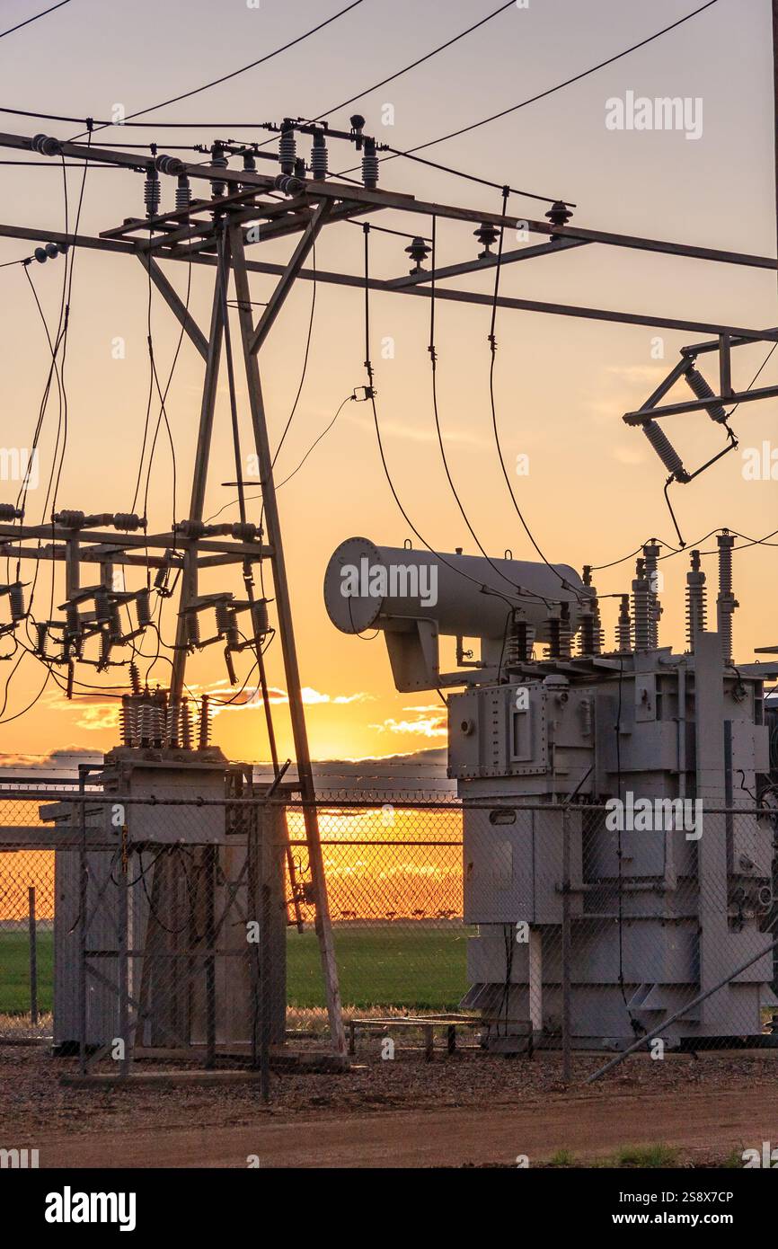 Power poles and transmission lines at sunset Stock Photo - Alamy