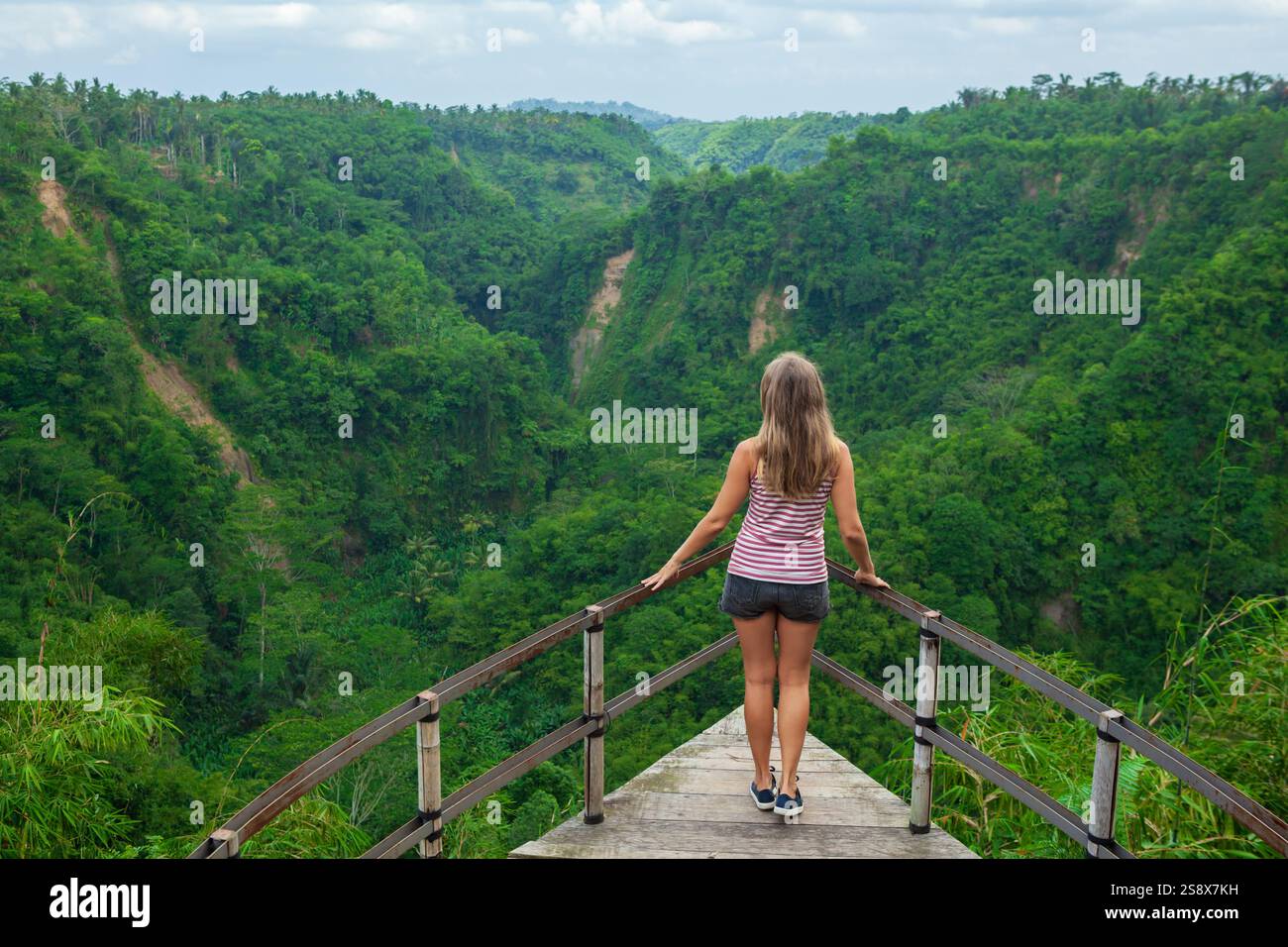 Family vacation lifestyle. Young woman stand on edge of overhanging ...