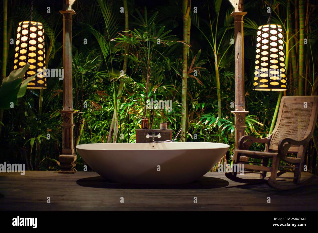 Luxury freestanding bathtub in a tropical outdoor setting, surrounded ...