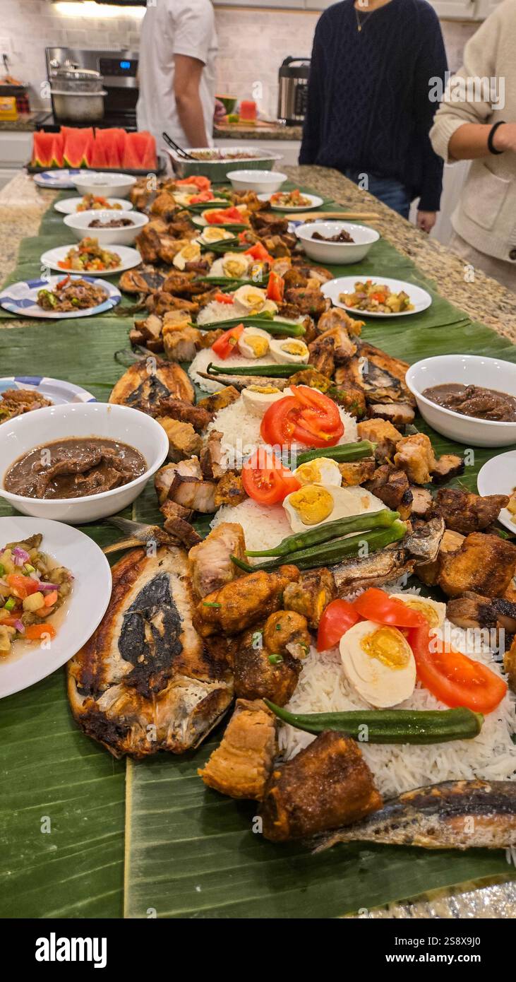 Food on the table for a Filipino Boodle Fight party Stock Photo - Alamy