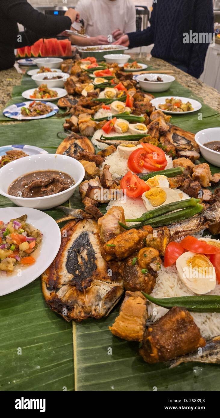 Food on the table for a Filipino Boodle Fight party Stock Photo - Alamy