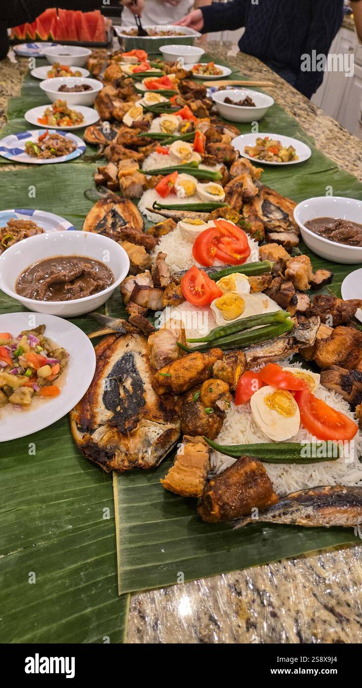 Food on the table for a Filipino Boodle Fight party Stock Photo - Alamy