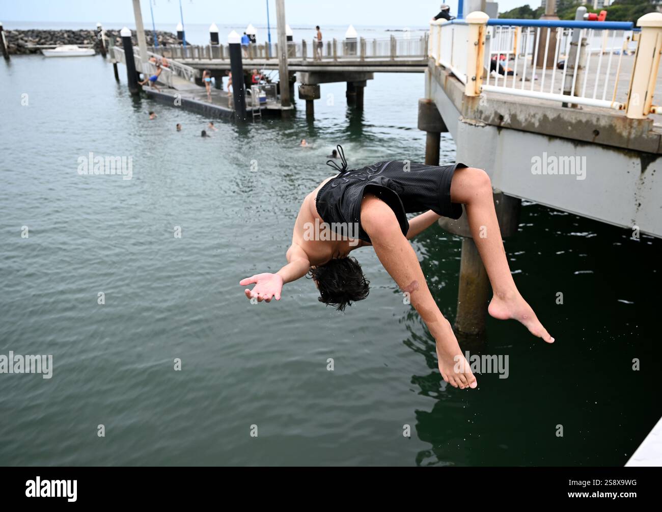 People are seen cooling off from the Redcliffe Jetty during high ...