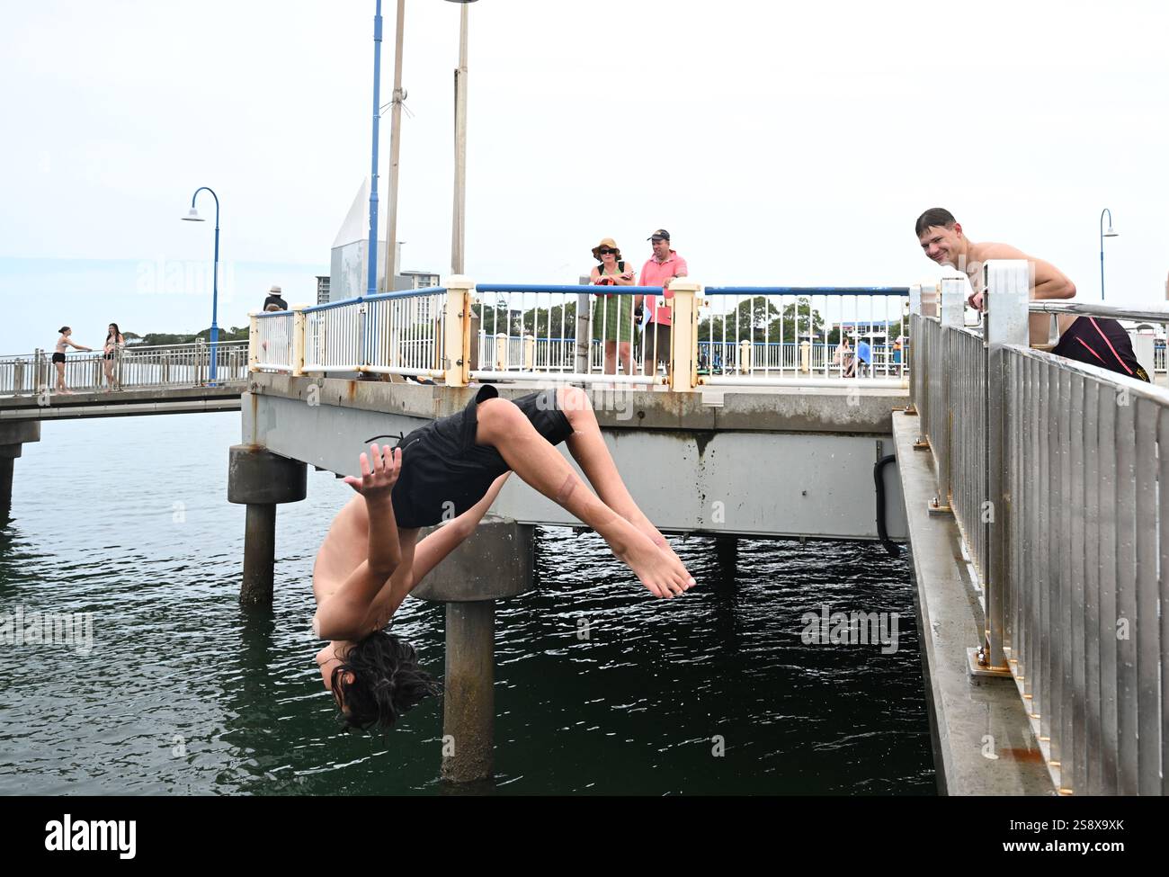 People are seen cooling off from the Redcliffe Jetty during high ...