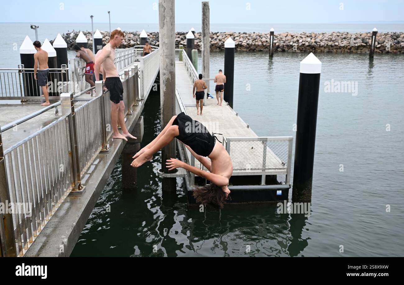 People are seen cooling off from the Redcliffe Jetty during high ...
