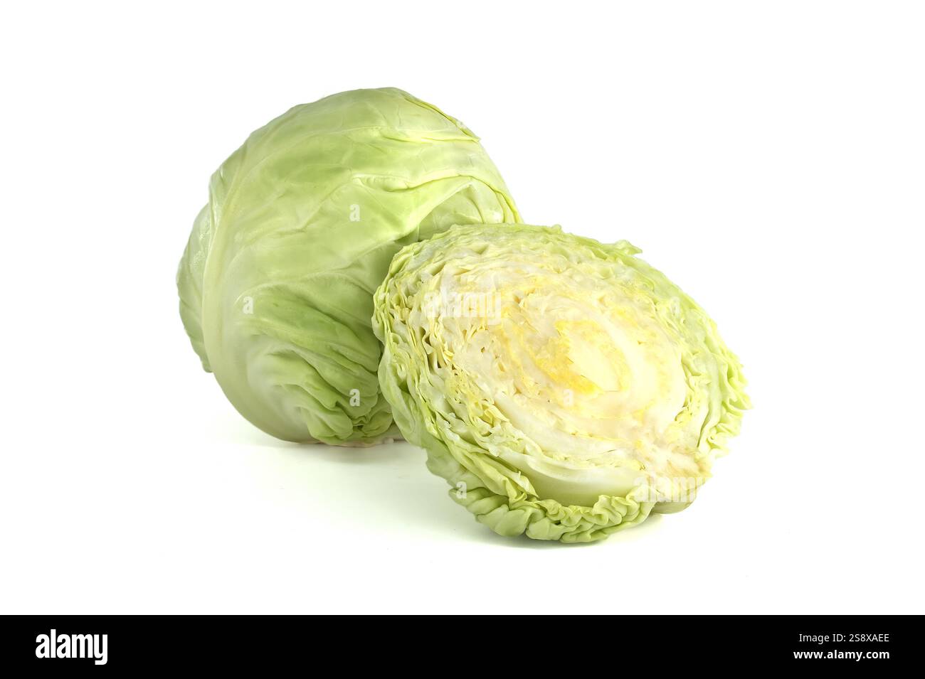 Close-up view of a whole green cabbage and a halved one showing ...