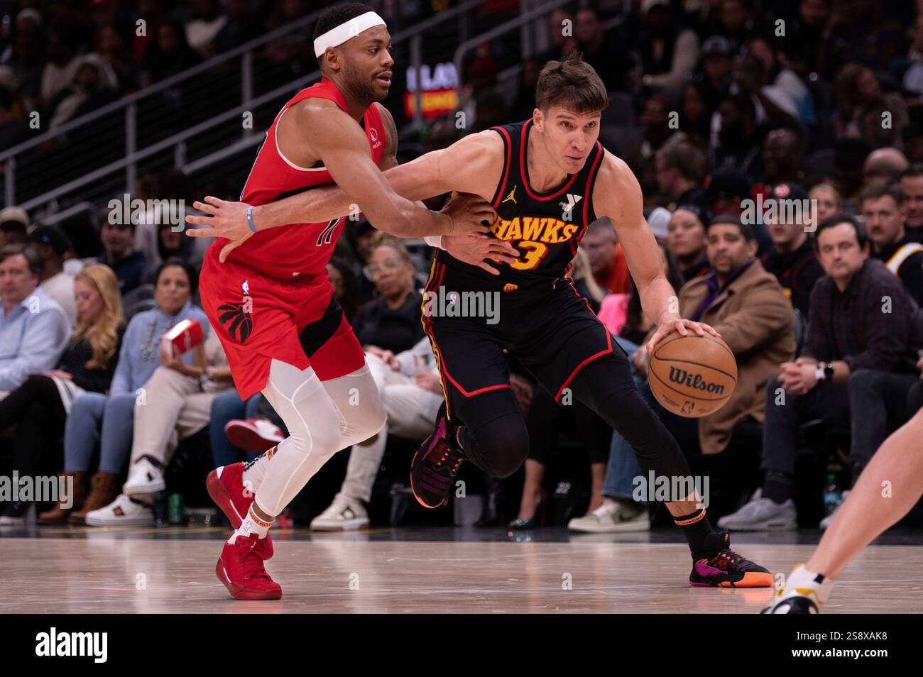 Atlanta Hawks guard Bogdan Bogdanovic (13) pushes past Toronto Raptors ...