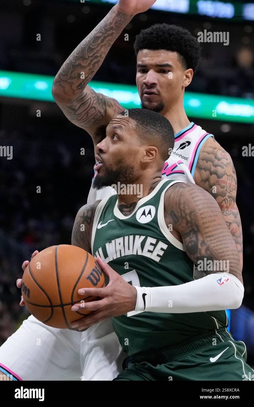 Milwaukee Bucks' Damian Lillard drives past Miami Heat's Kel'el Ware ...