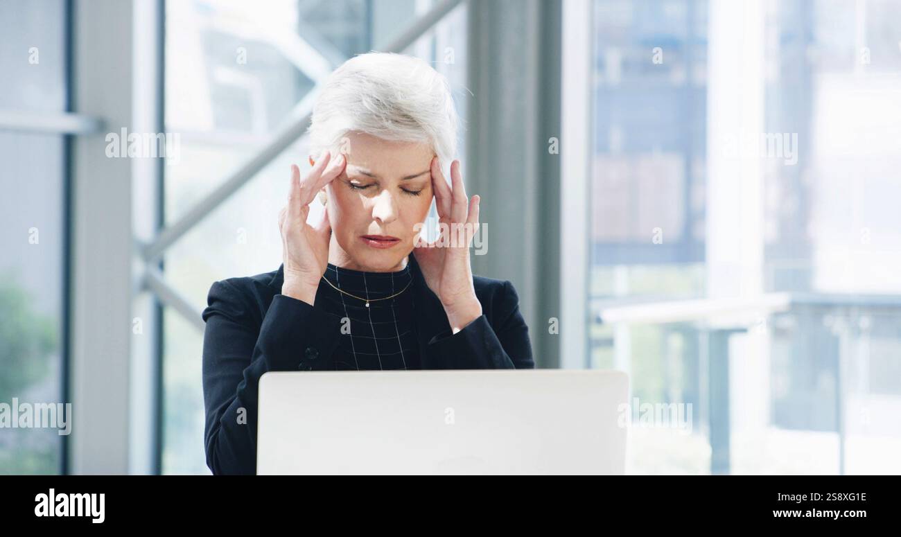 Business, computer and mature woman with headache in modern office ...