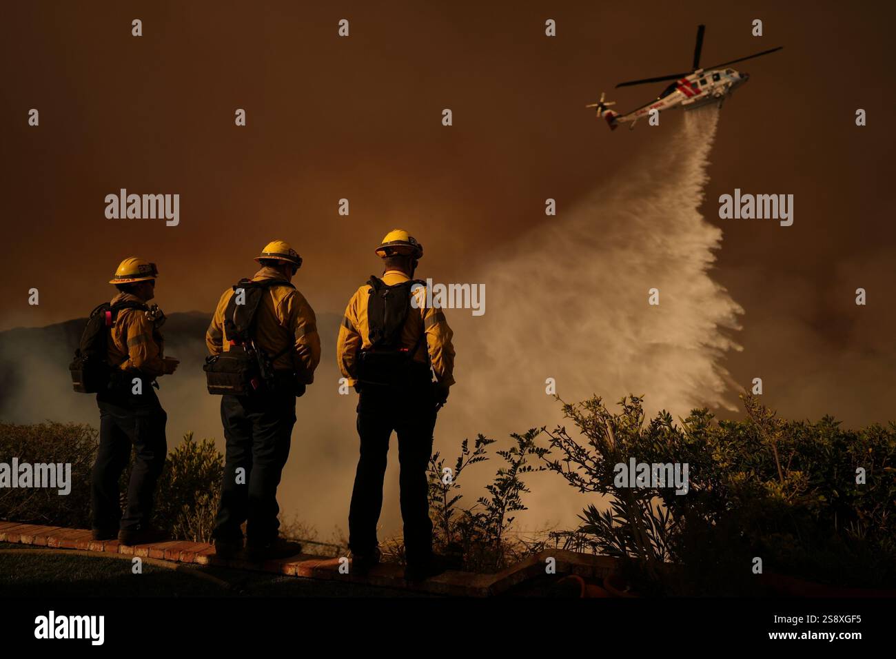 FILE - Water is dropped by helicopter on the Palisades Fire in ...