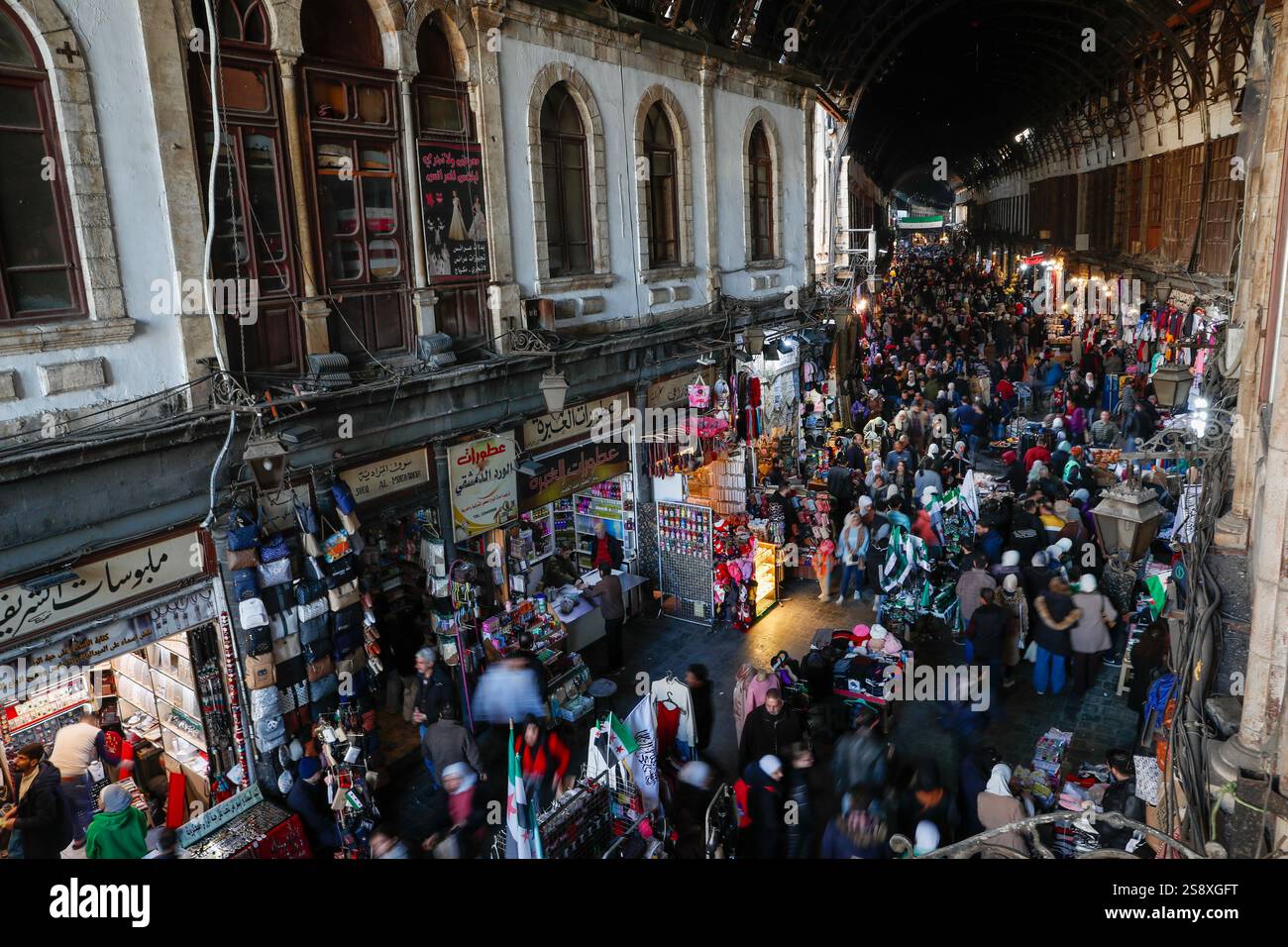 Shoppers walk through the old city market in Damascus, Syria, Thursday ...