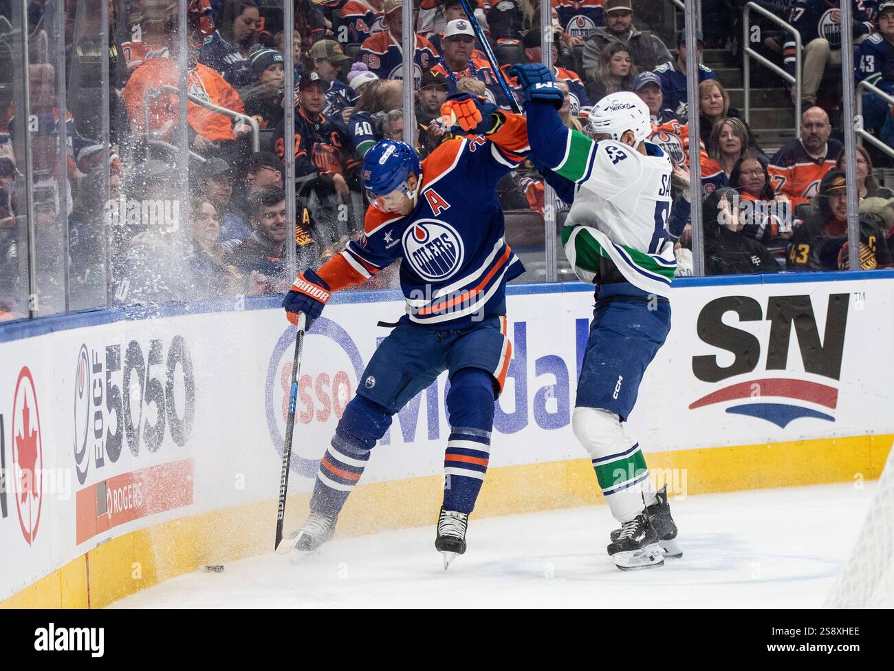 Vancouver Canucks' Max Sasson (63) checks Edmonton Oilers' Darnell ...