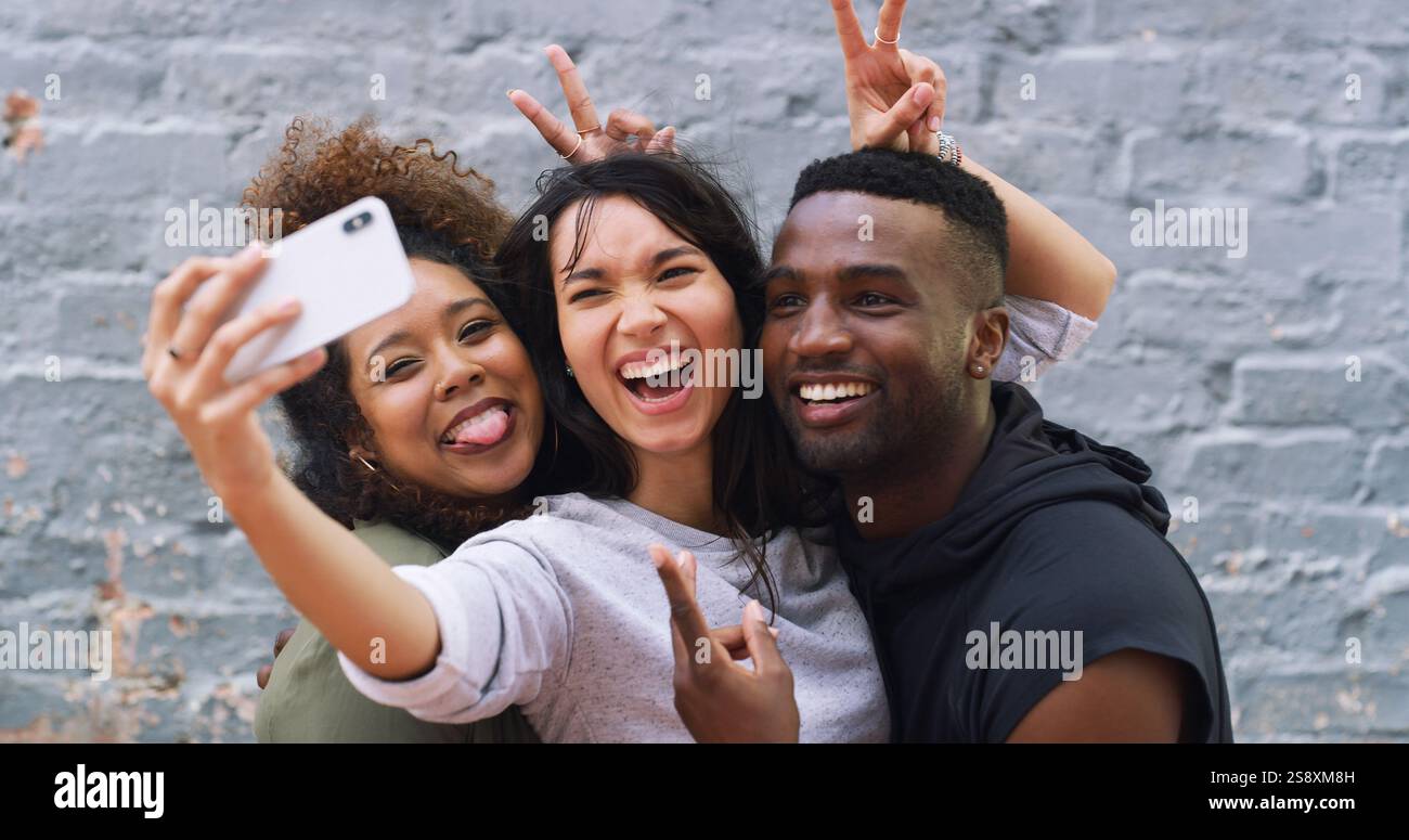 Selfie, funny and group of people by wall in city for memory, social ...