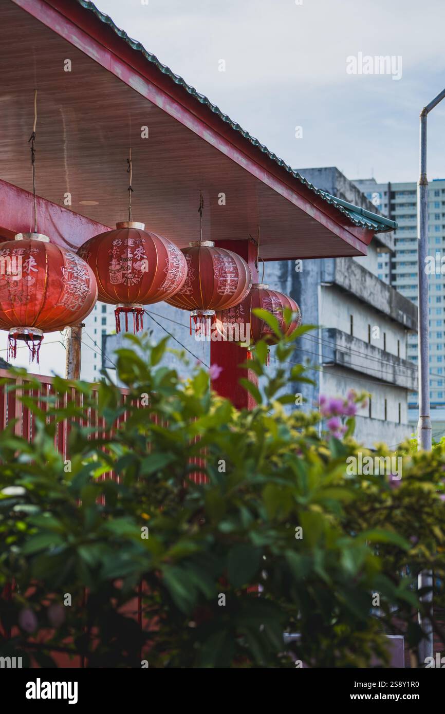 A colorful image of Chinese lanterns hanging in a row. These lanterns are typically made of silk ...