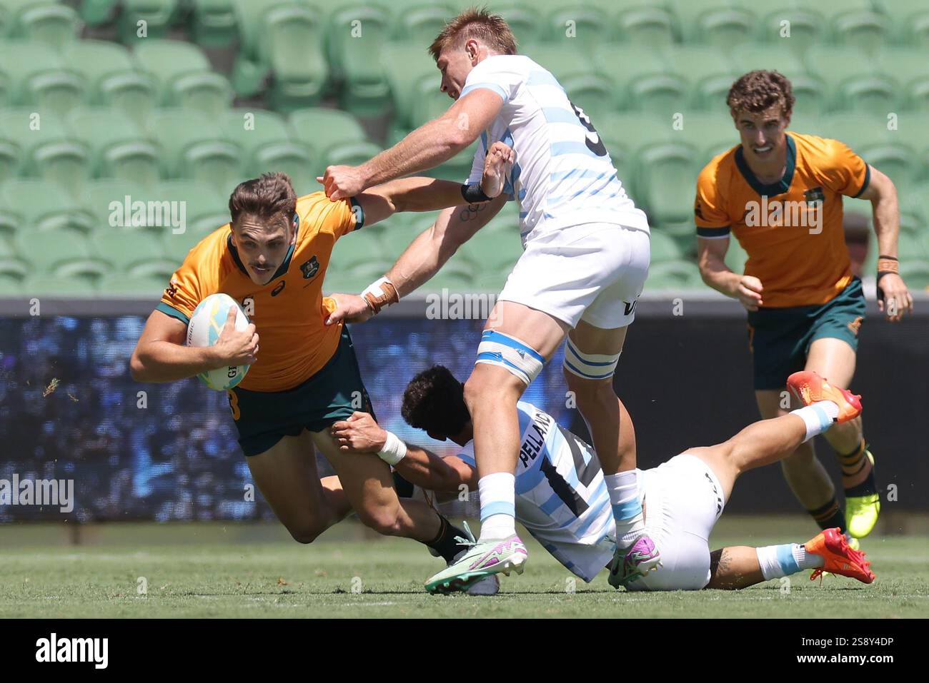 Jayden Blake of Australia is tackled by Matias Osadczuk of Argentina ...