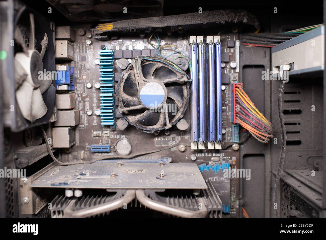 Dusty computer interior showing the motherboard, CPU fan, RAM sticks ...