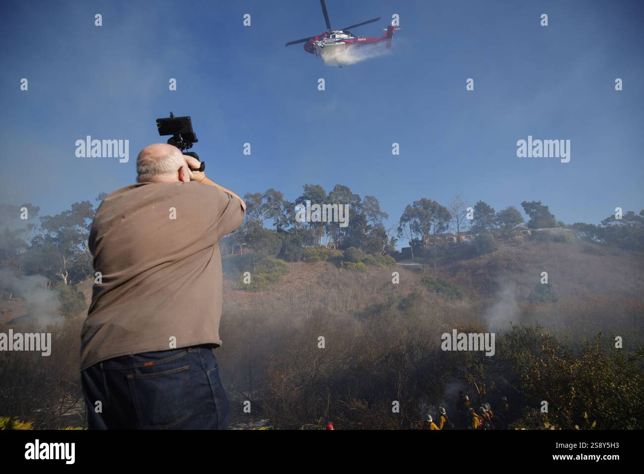 An aircraft from San Diego Fire Department provides air support to ...