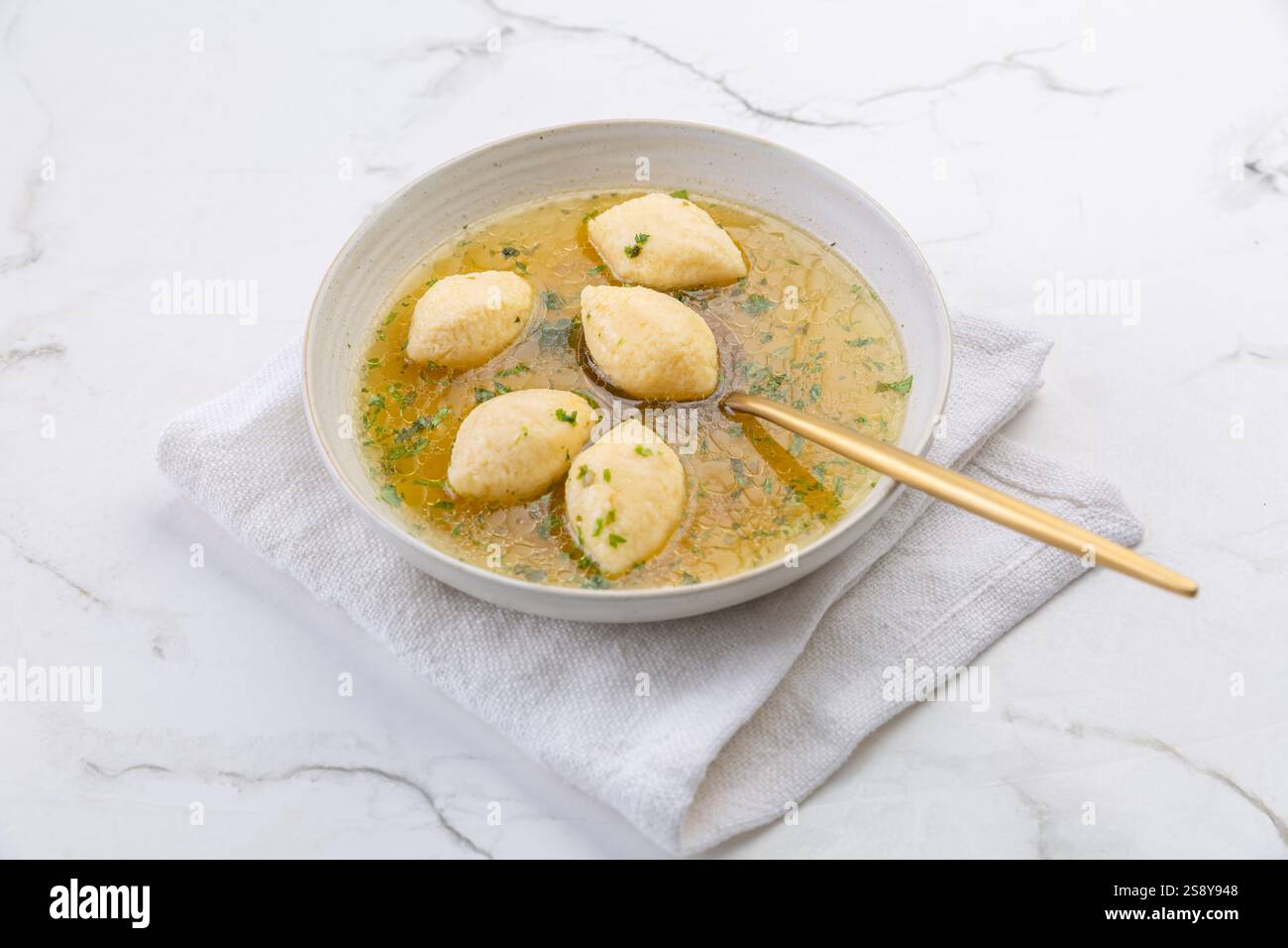 Chicken broth, clear bouillon soup with semolina dumplings Stock Photo ...