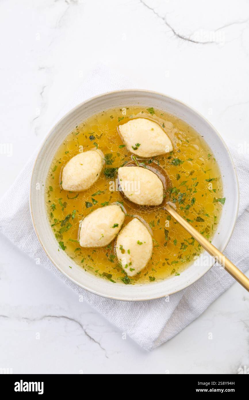 Chicken broth, clear bouillon soup with semolina dumplings Stock Photo ...