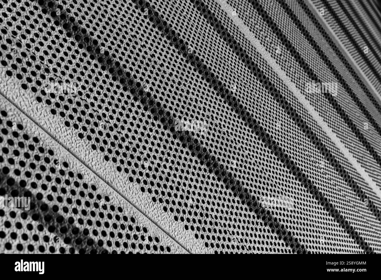 Textured metal surface with circular perforations in a modern ...