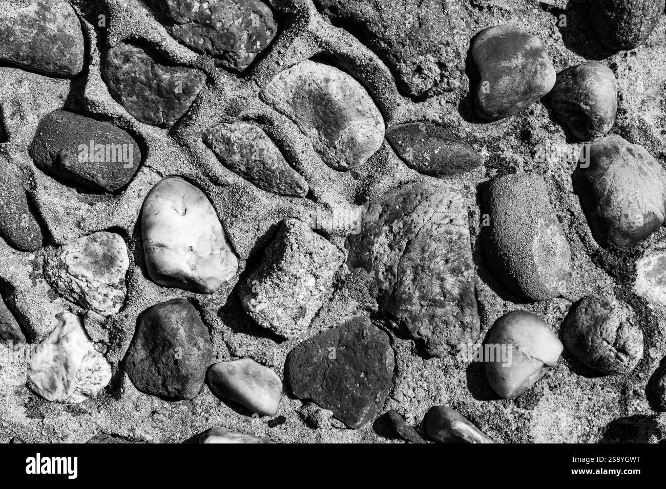 Interesting patterns created by smooth stones on sandy ground during ...