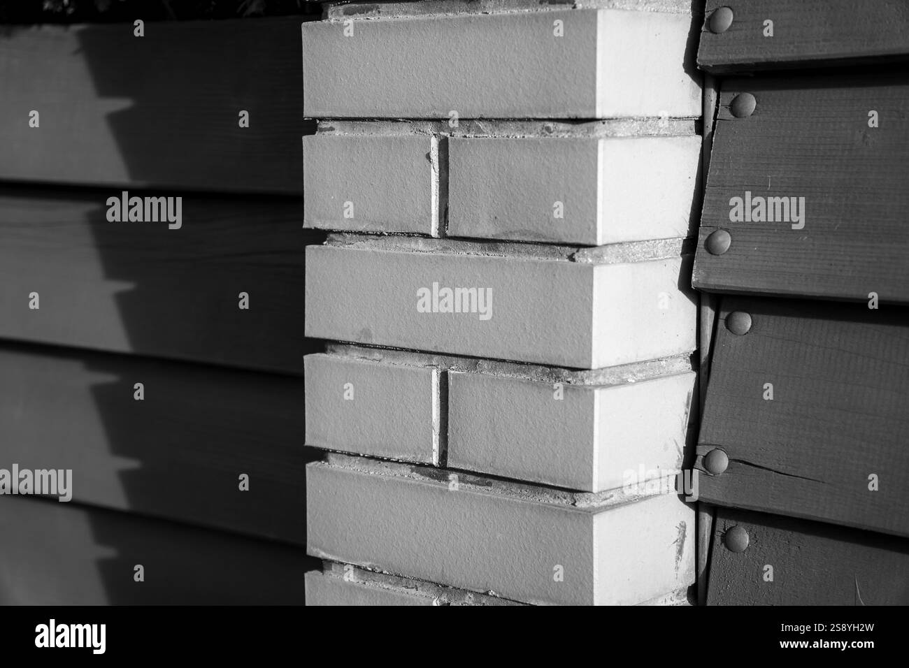 Architectural corner detail showcasing textured materials in monochrome ...