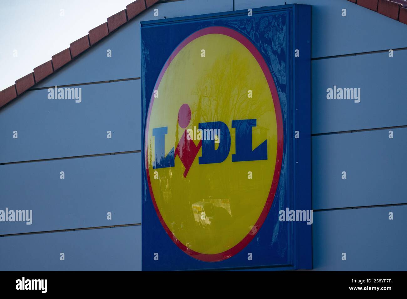 Lidl store sign displays brand logo in bright colors under clear sky on ...
