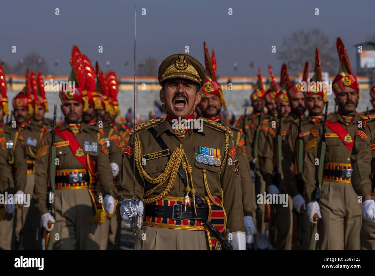An Indian Border Security Force (BSF) officer center, gives a command ...